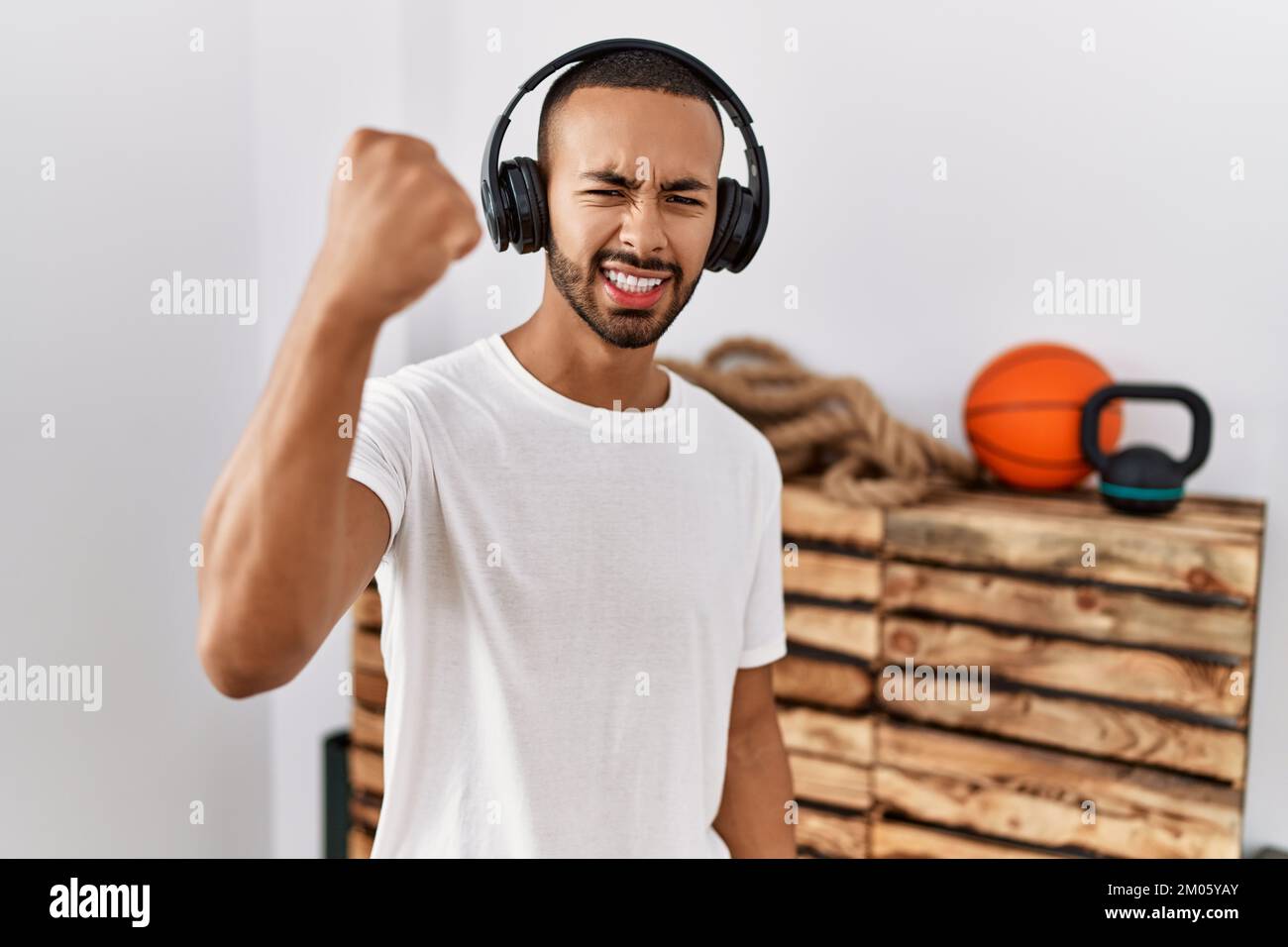 African american man listening to music using headphones at the gym ...