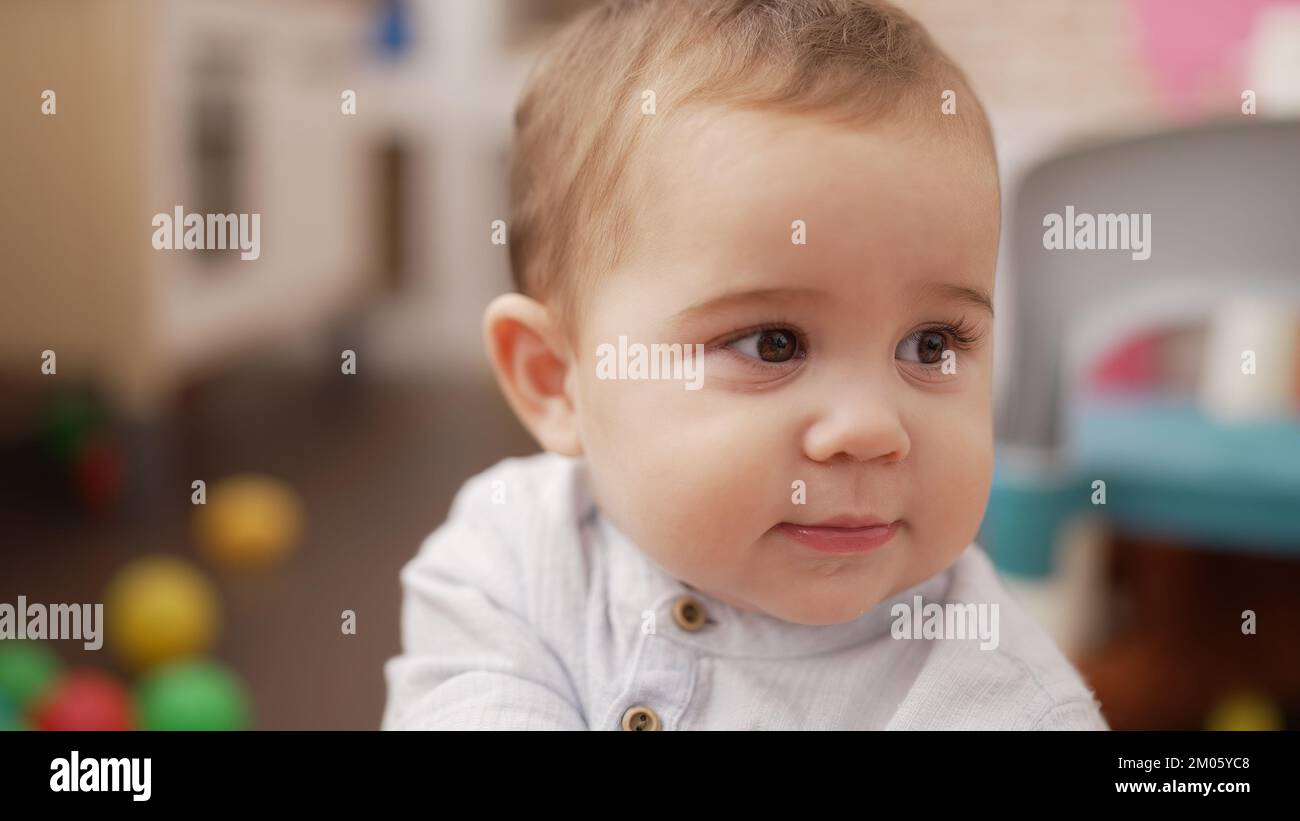 Adorable toddler standing with serious expression at kindergarten Stock ...