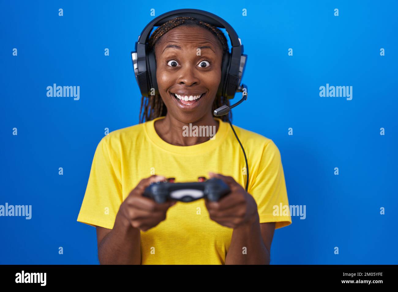African american woman playing video games celebrating crazy and amazed ...