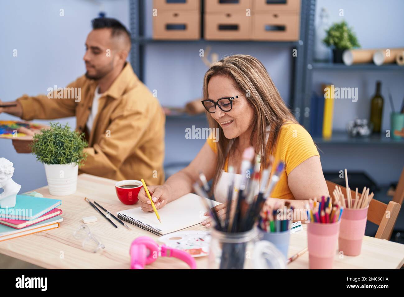 Man and woman artists smiling confident drawing at art studio Stock ...
