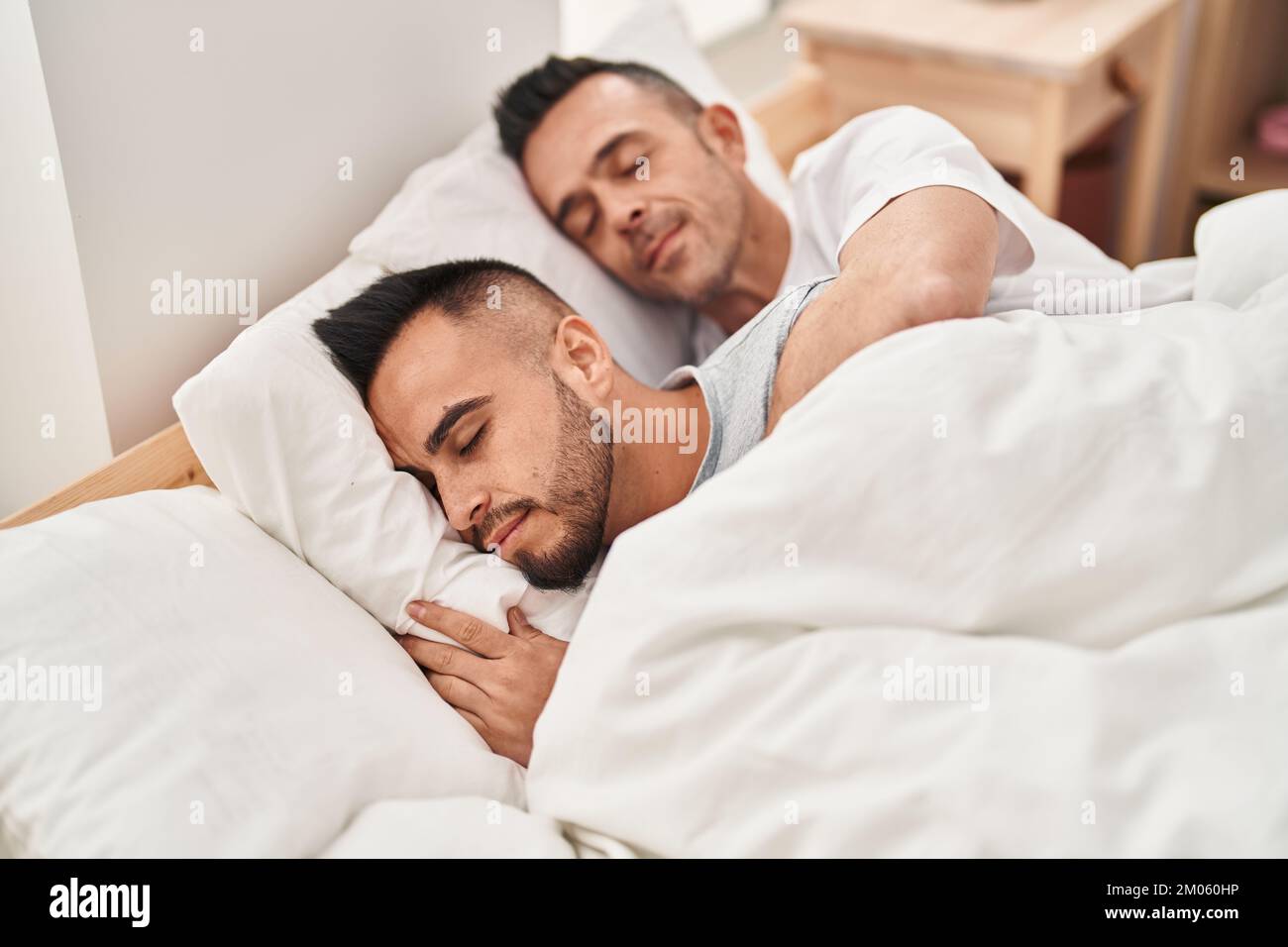 Two men couple lying on bed sleeping at bedroom Stock Photo - Alamy