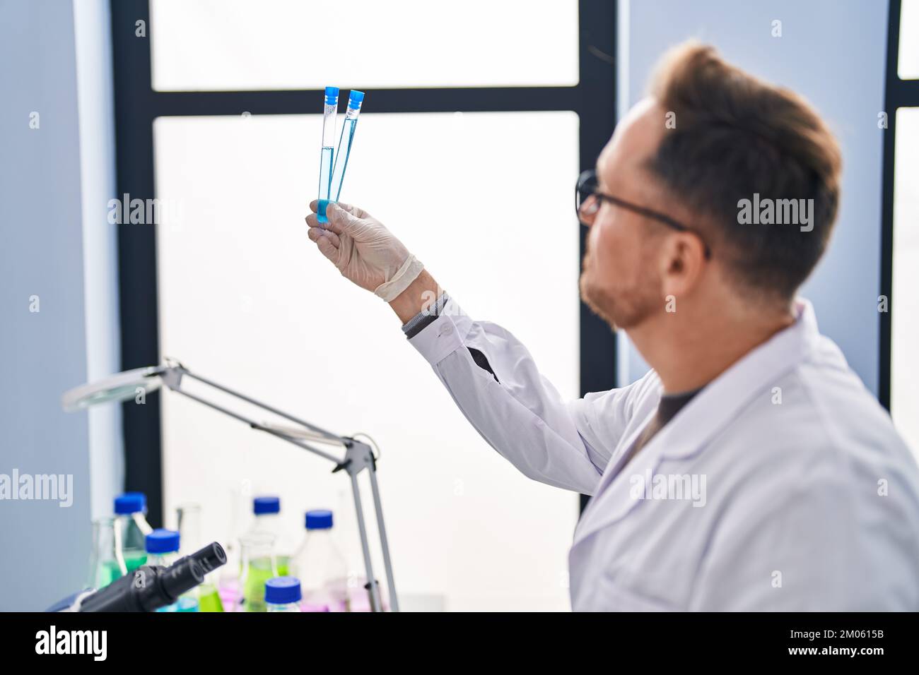 Young caucasian man scientist holding test tubes at laboratory Stock ...