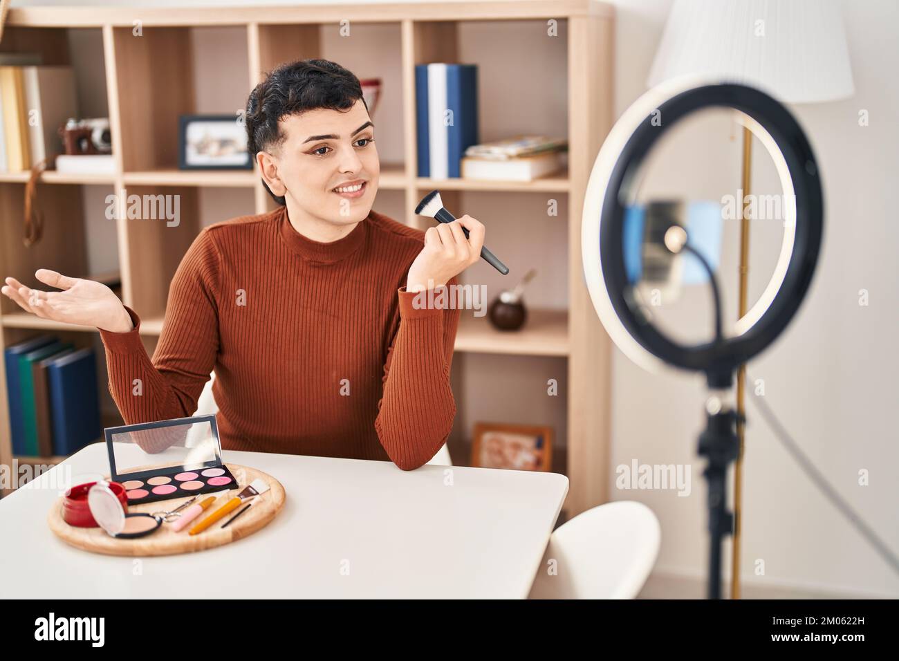 Non binary person recording vlog tutorial with smartphone at home ...