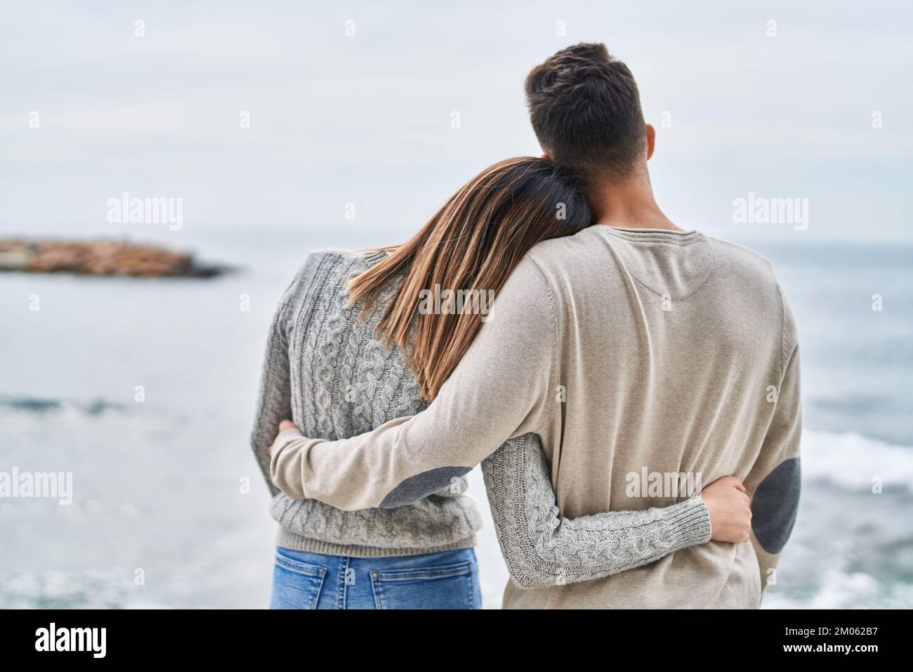 Man And Woman Couple Hugging Each Other On Back View At Seaside Stock