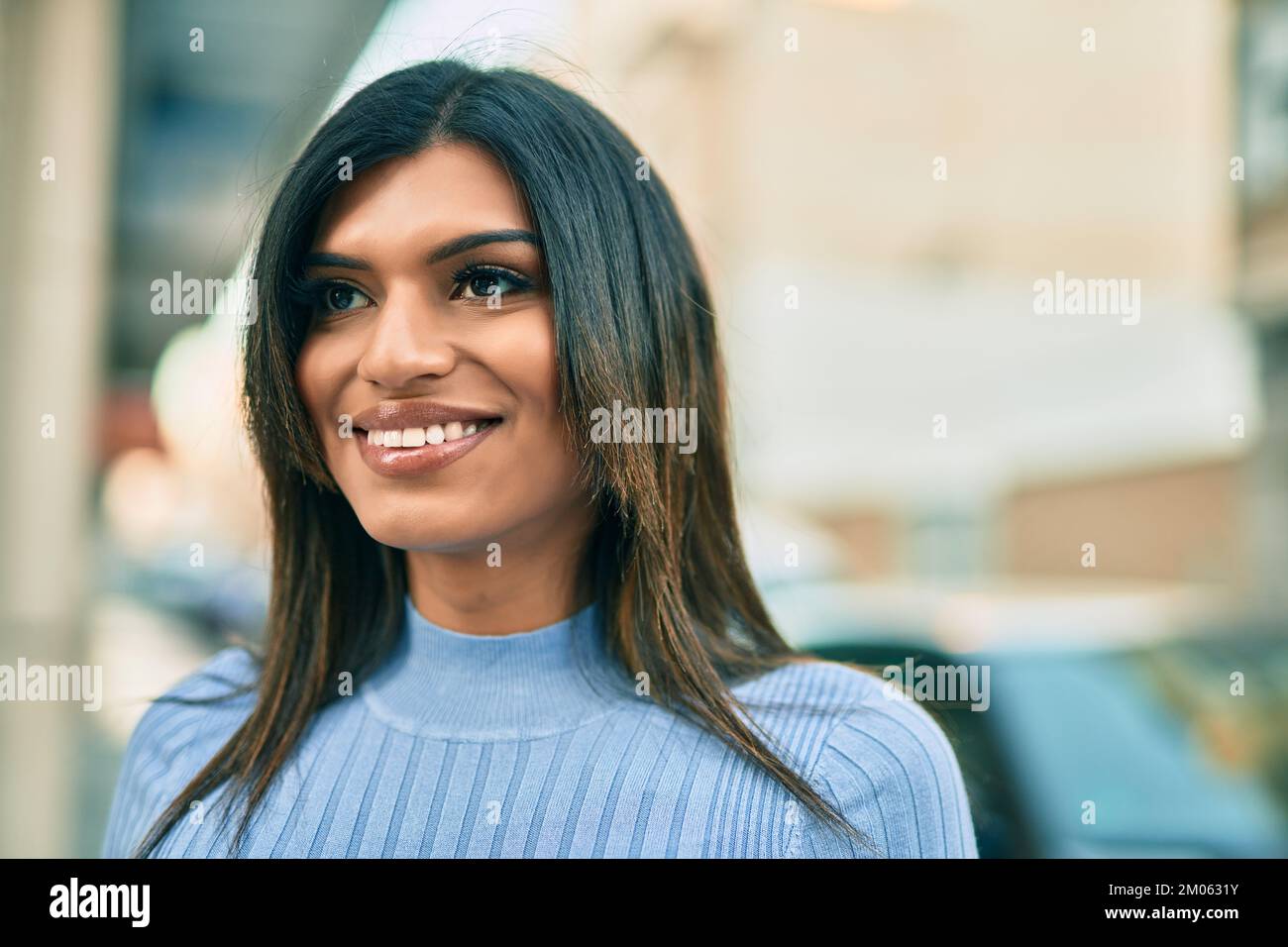 Beautiful hispanic woman smiling confient at the city Stock Photo - Alamy