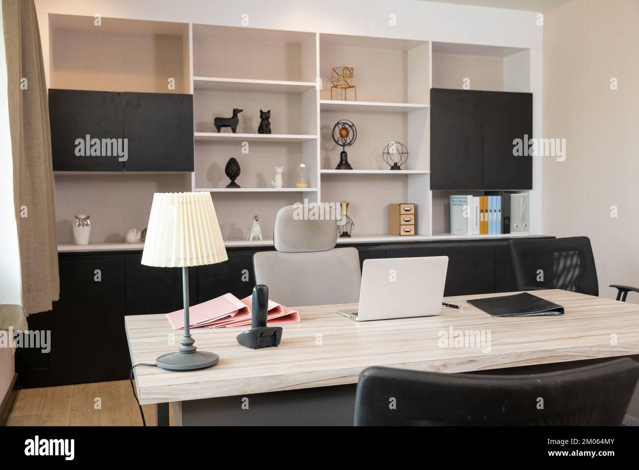 Comfortable office chair near wooden table with laptop computer Stock ...