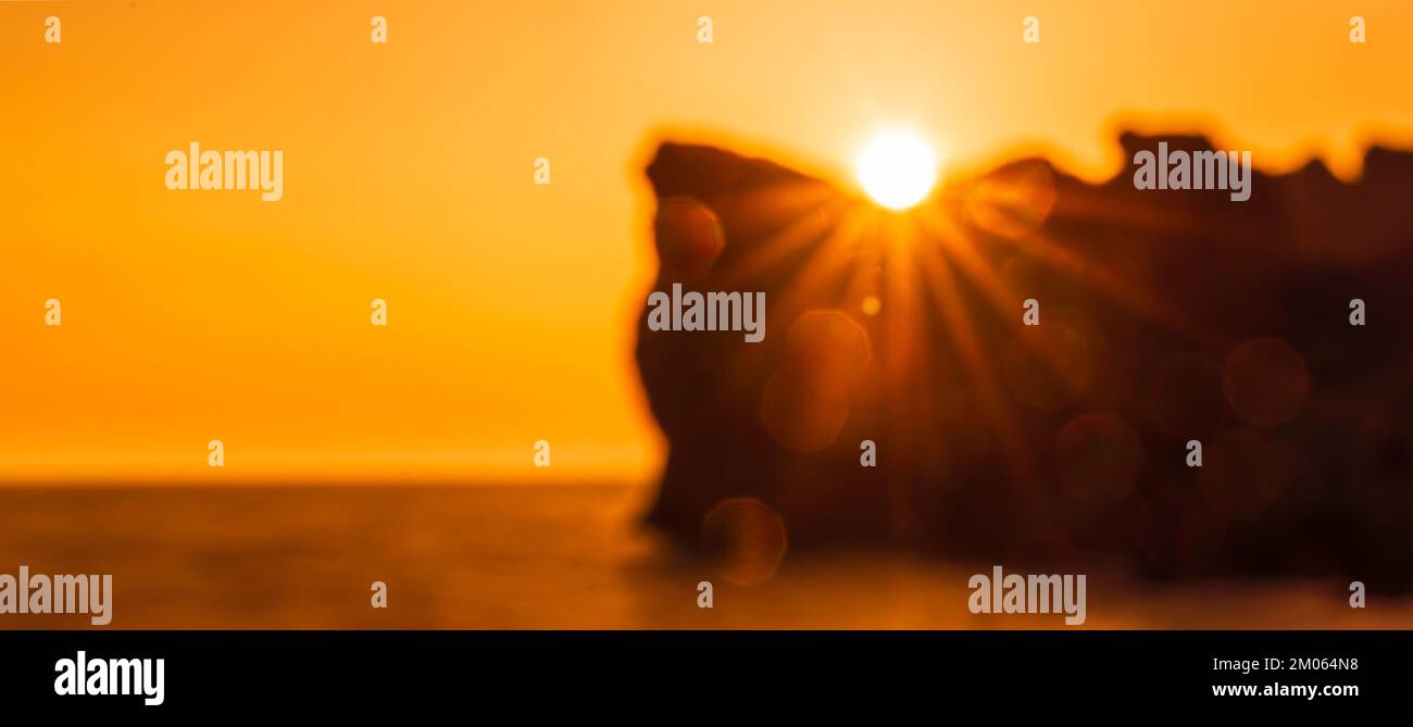 Banner. In blur An epic sunset on the sea - the sun sets behind the ...