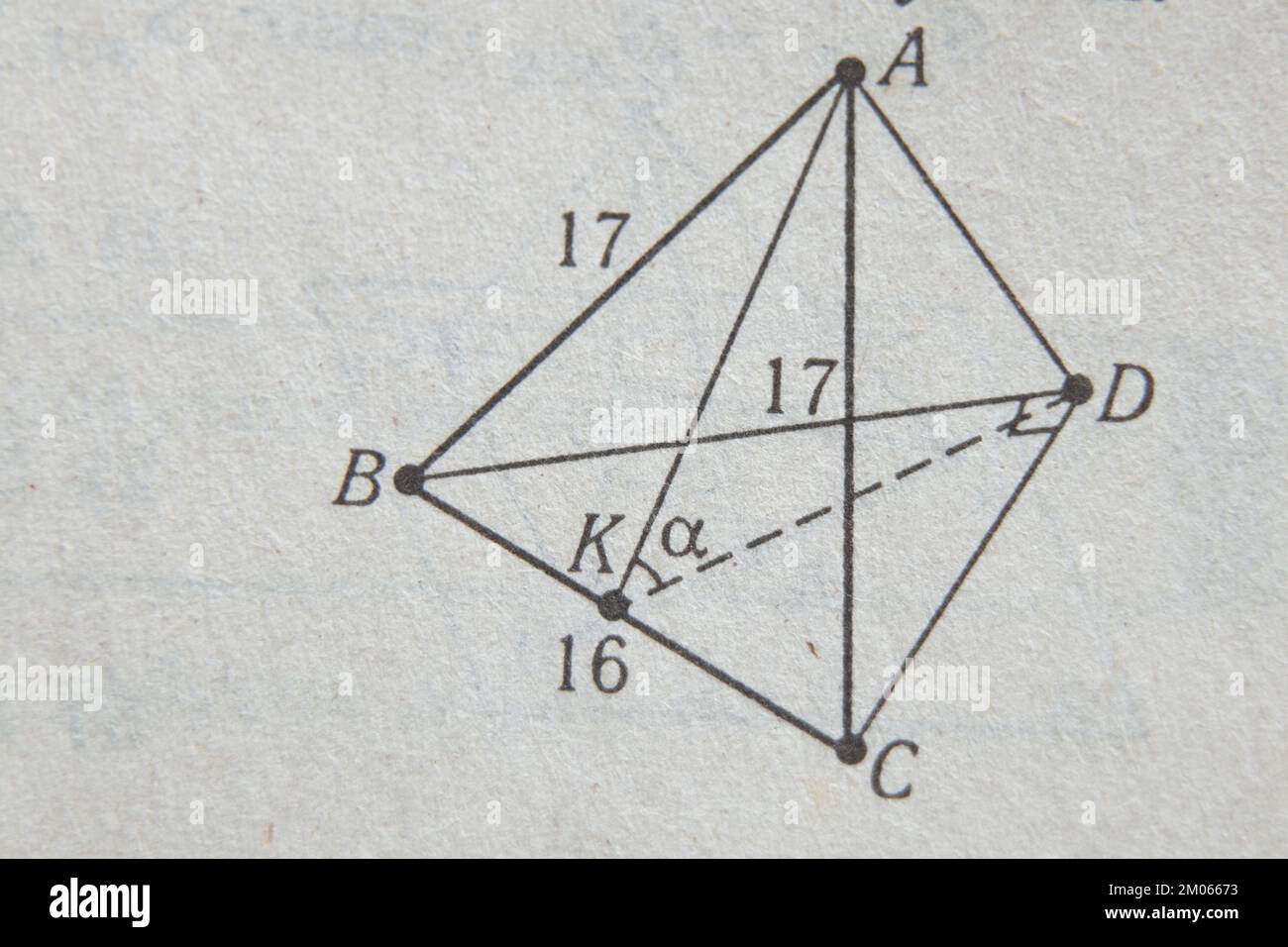 geometry drawing on page of old yellow book as background, algebra book ...