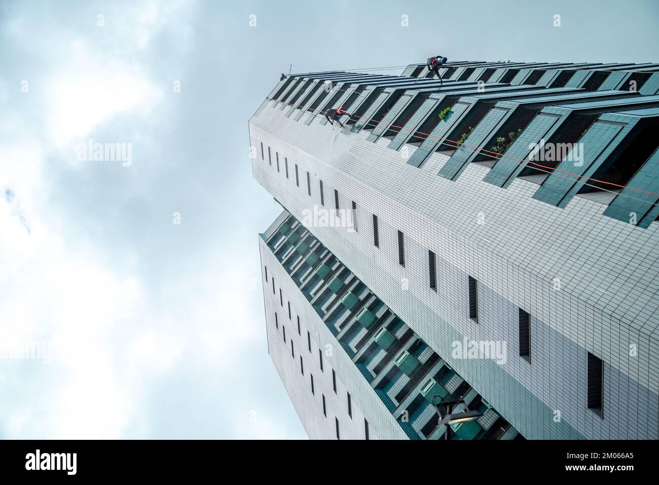 cleaning walls and glass of high-rise buildings in a big city Stock ...