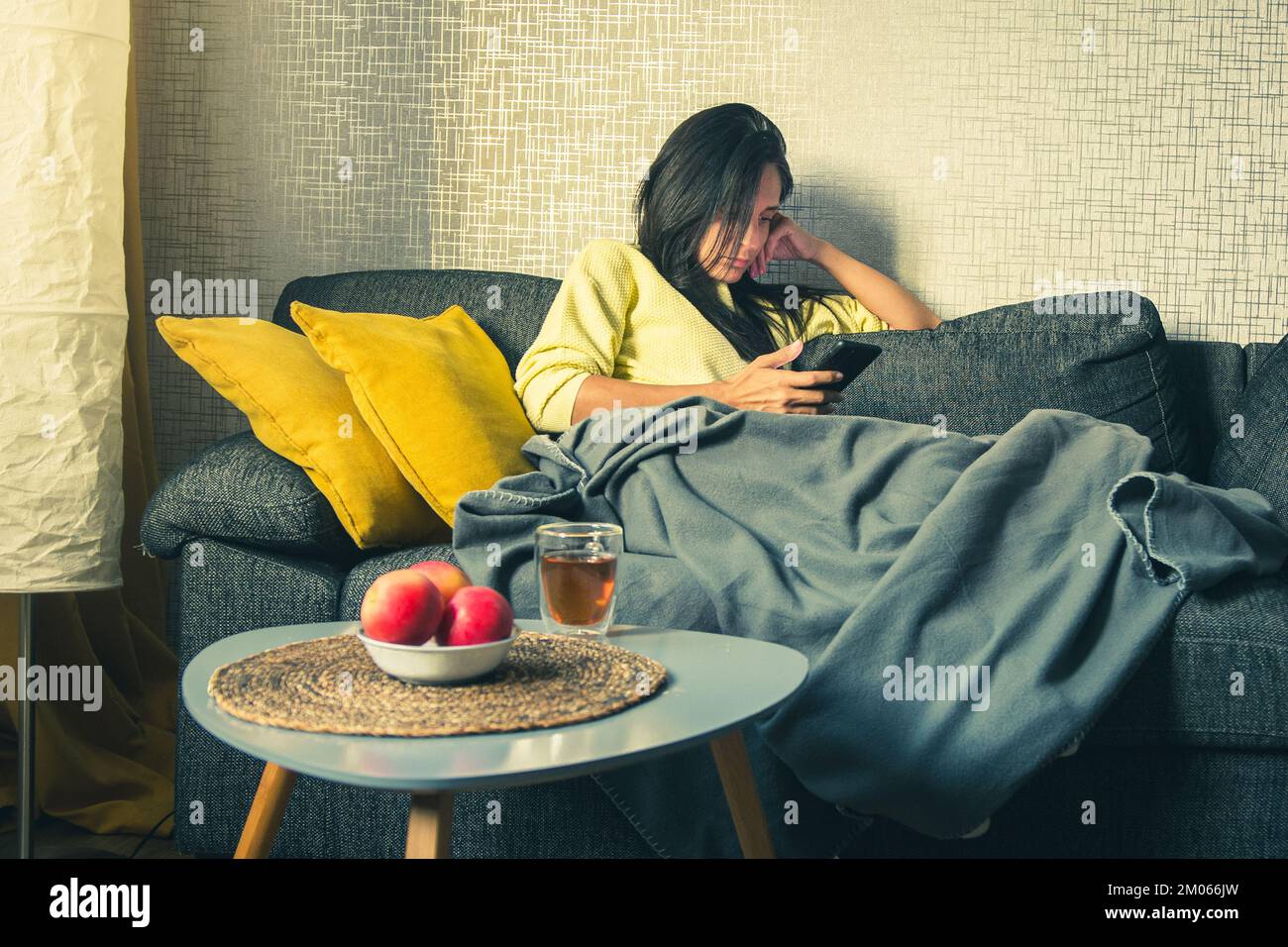 Caucasian modern woman in suit sit on coach scroll do shopping use ...