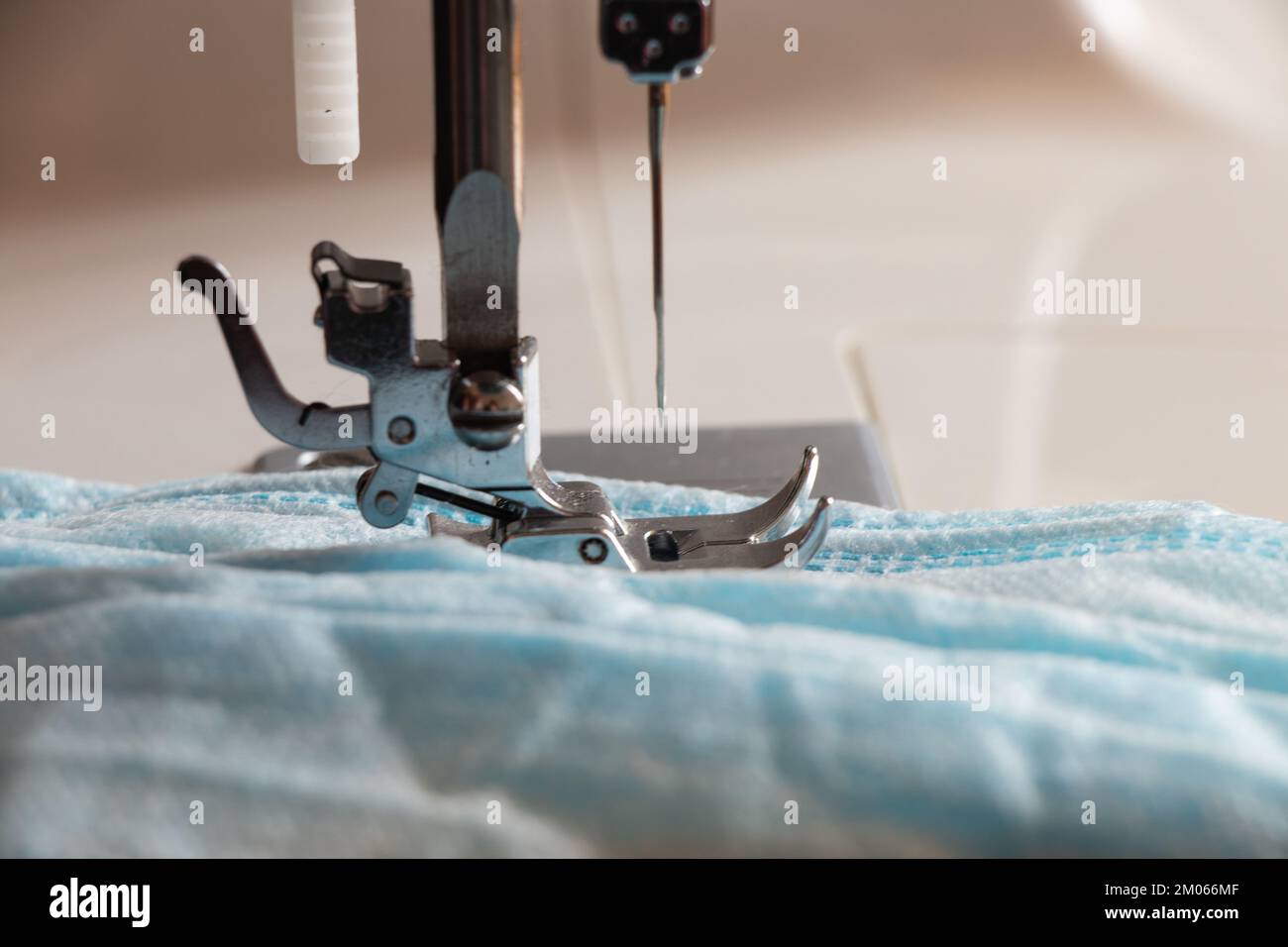 new sewing machine sews a medical mask close-up during Stock Photo - Alamy