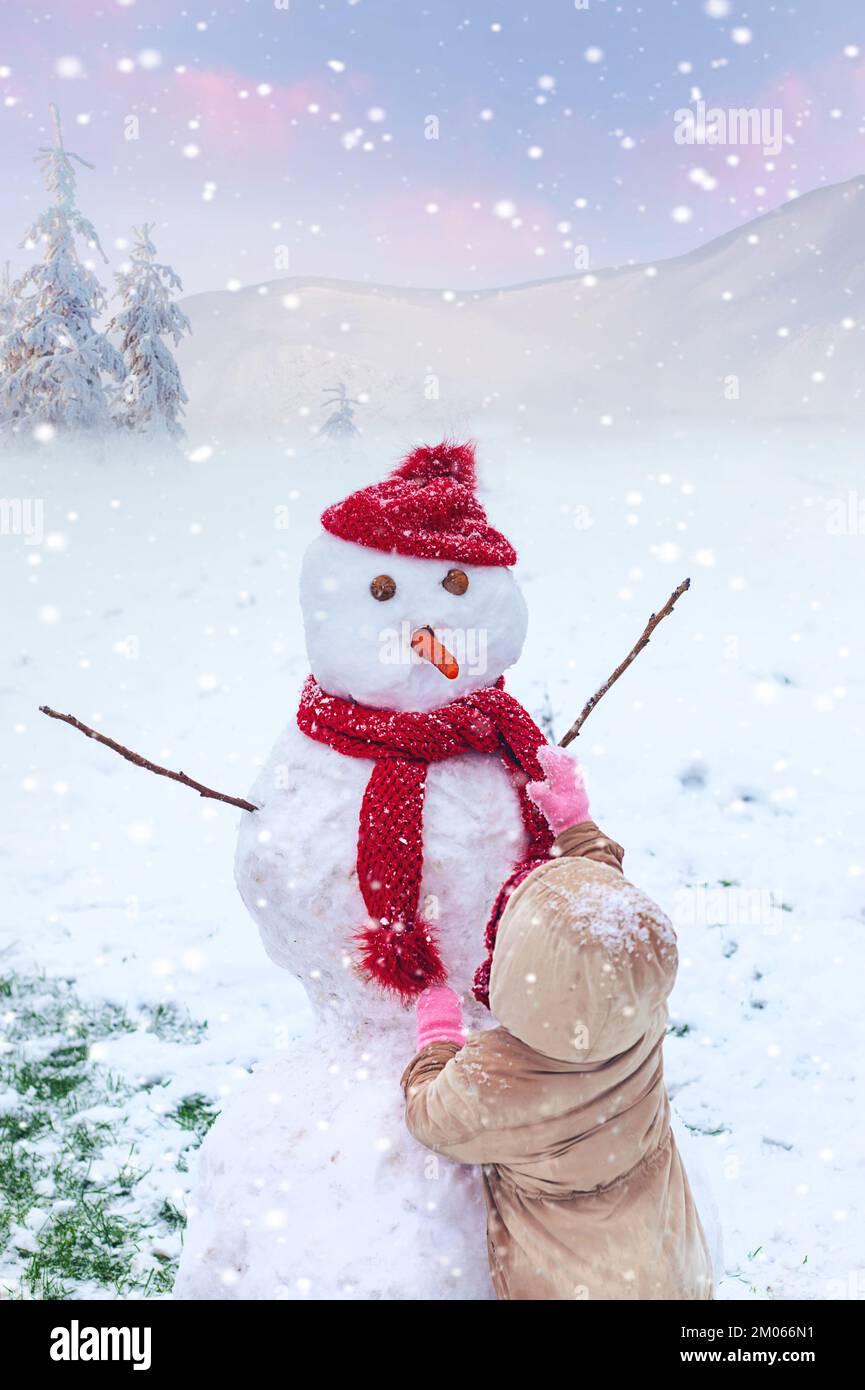 Children make a snowman in winter. Selective focus. Kid Stock Photo - Alamy