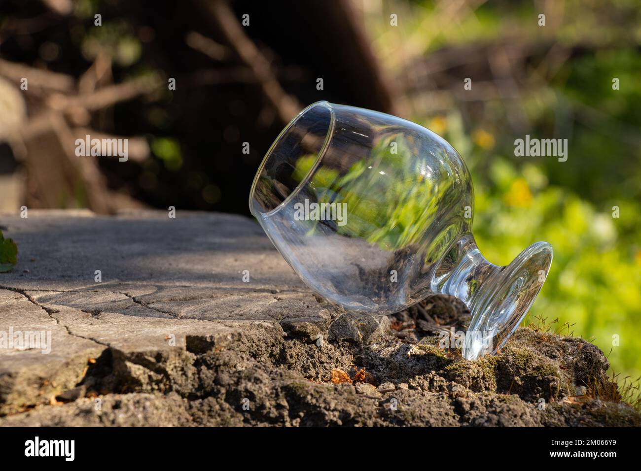 an empty transparent glass goblet stands on the ground Stock Photo - Alamy