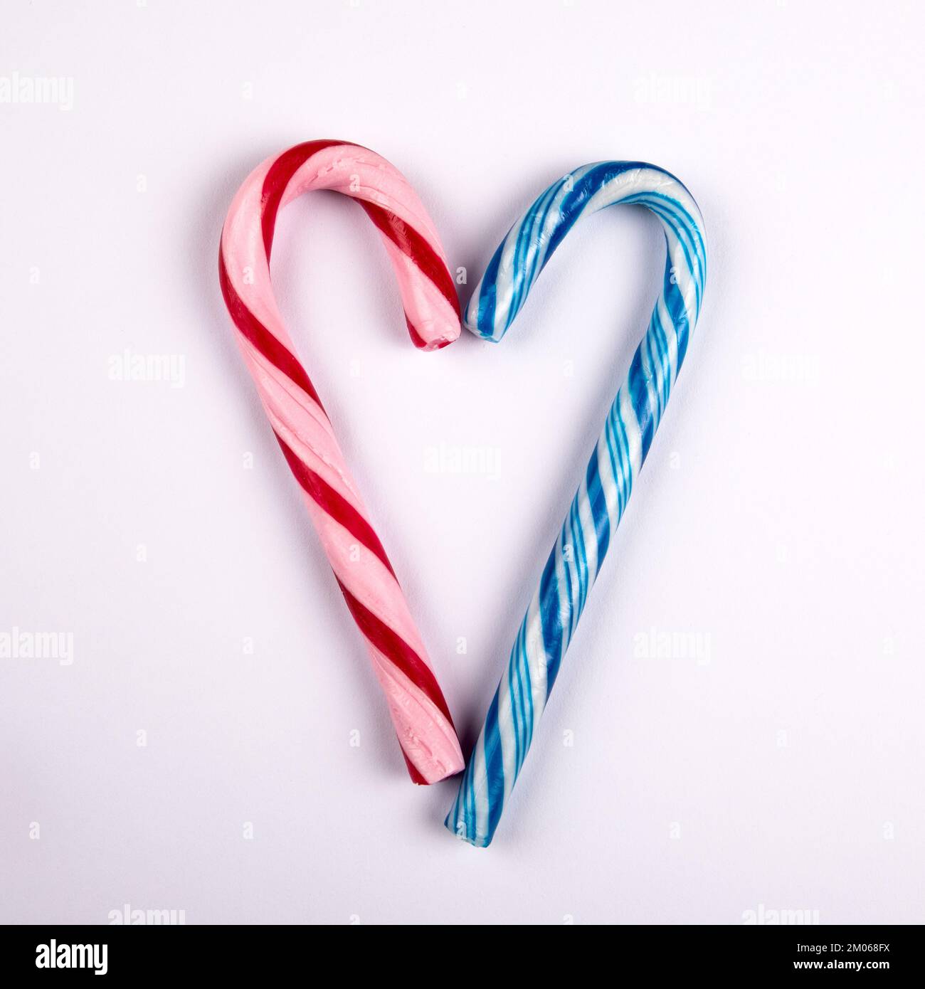 Blue and red candy cane in the shape of a heart on a white background ...