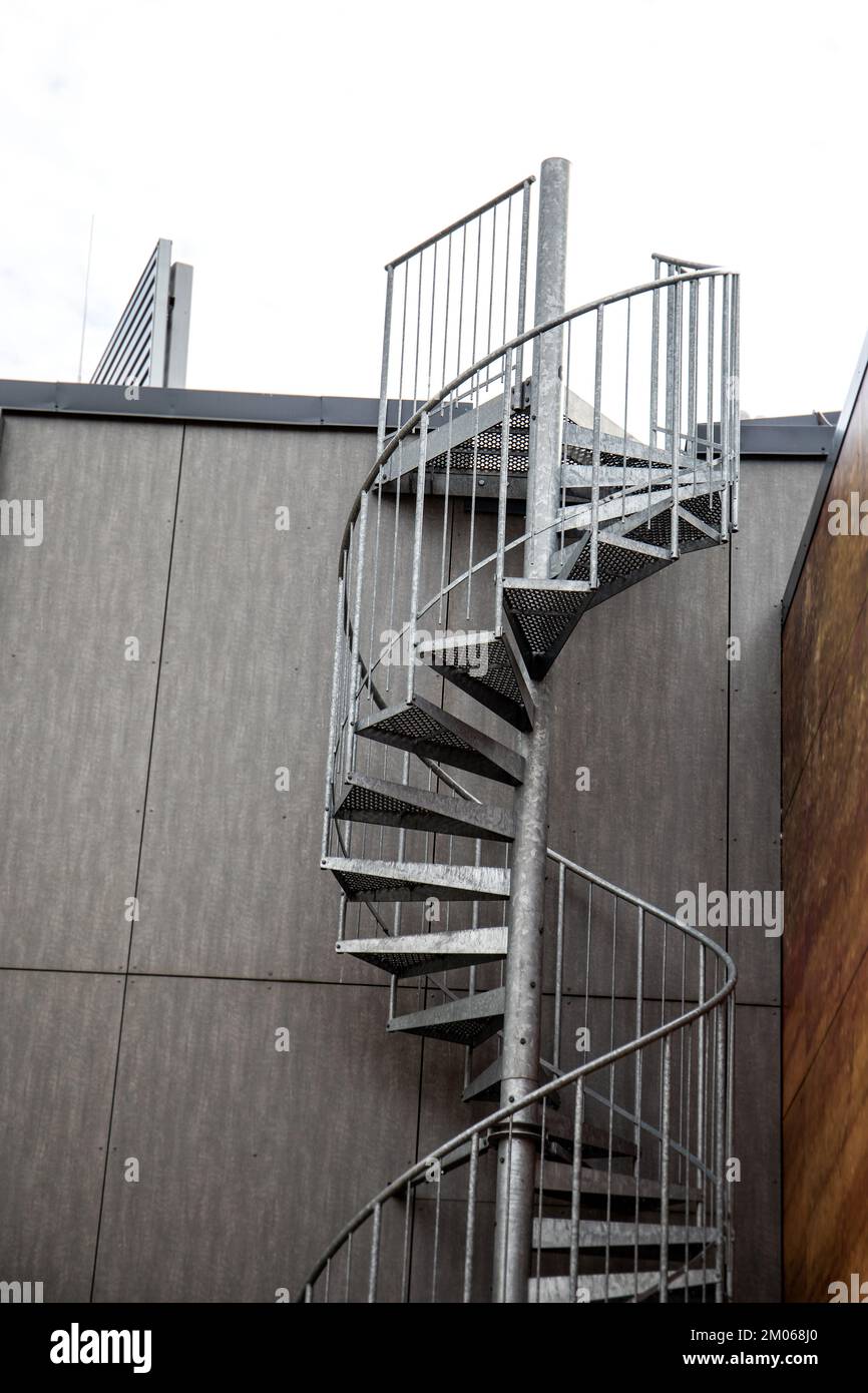 Emergency exit metal spiral staircase. Facade of the building Stock ...