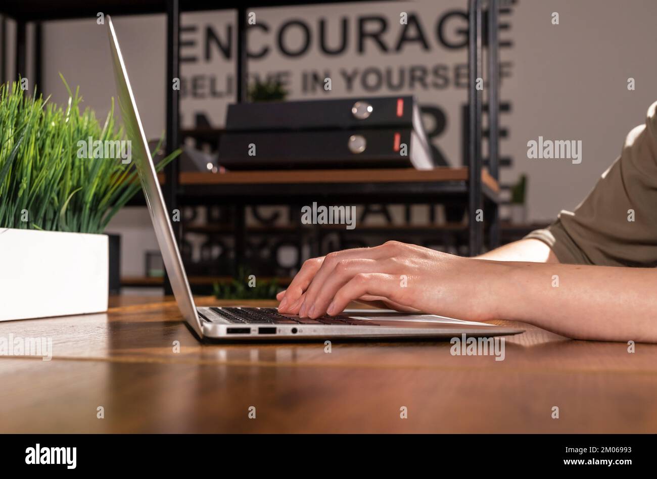 Work at laptop computer, PC in modern office interior. Hands typing on ...