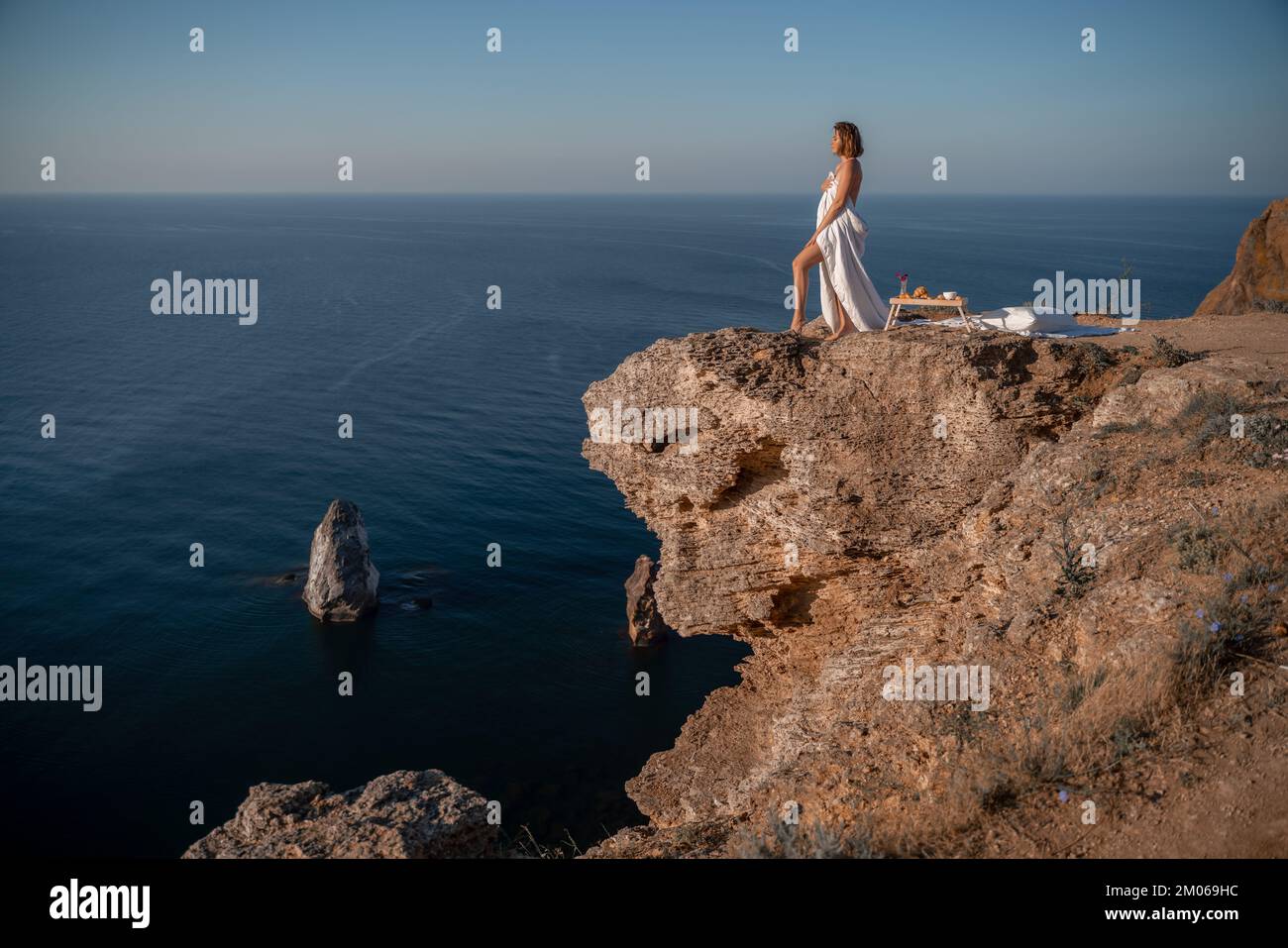 Woman wake up in bed wuth duvet and pillow over nature sea background ...