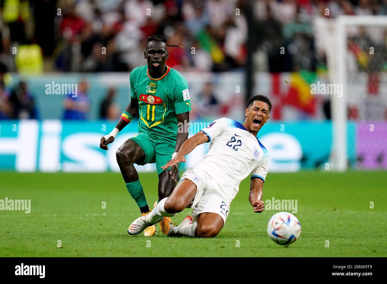 England's Jude Bellingham is tackled by Senegal's Pathe Ciss, (left ...