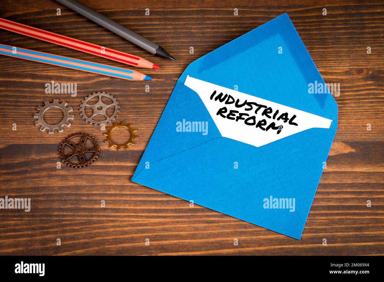 Industrial Reform. Letter in blue envelope on wooden texture table ...