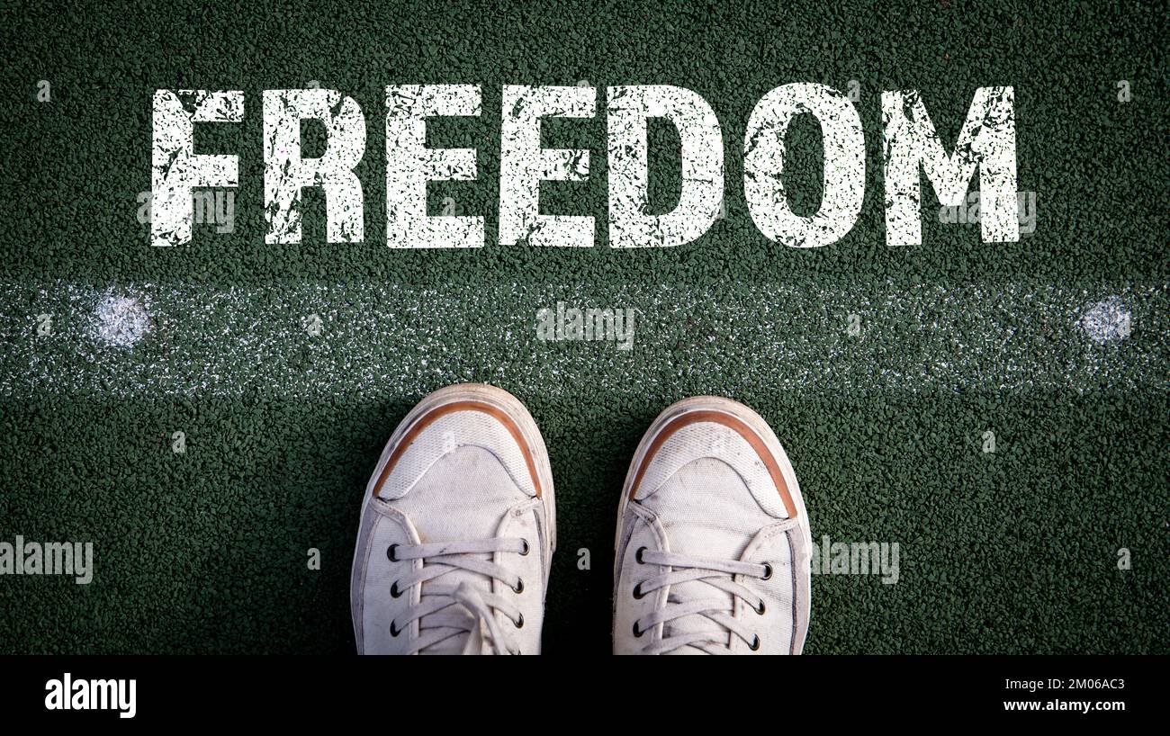Freedom concept. White sneakers at the starting line Stock Photo - Alamy