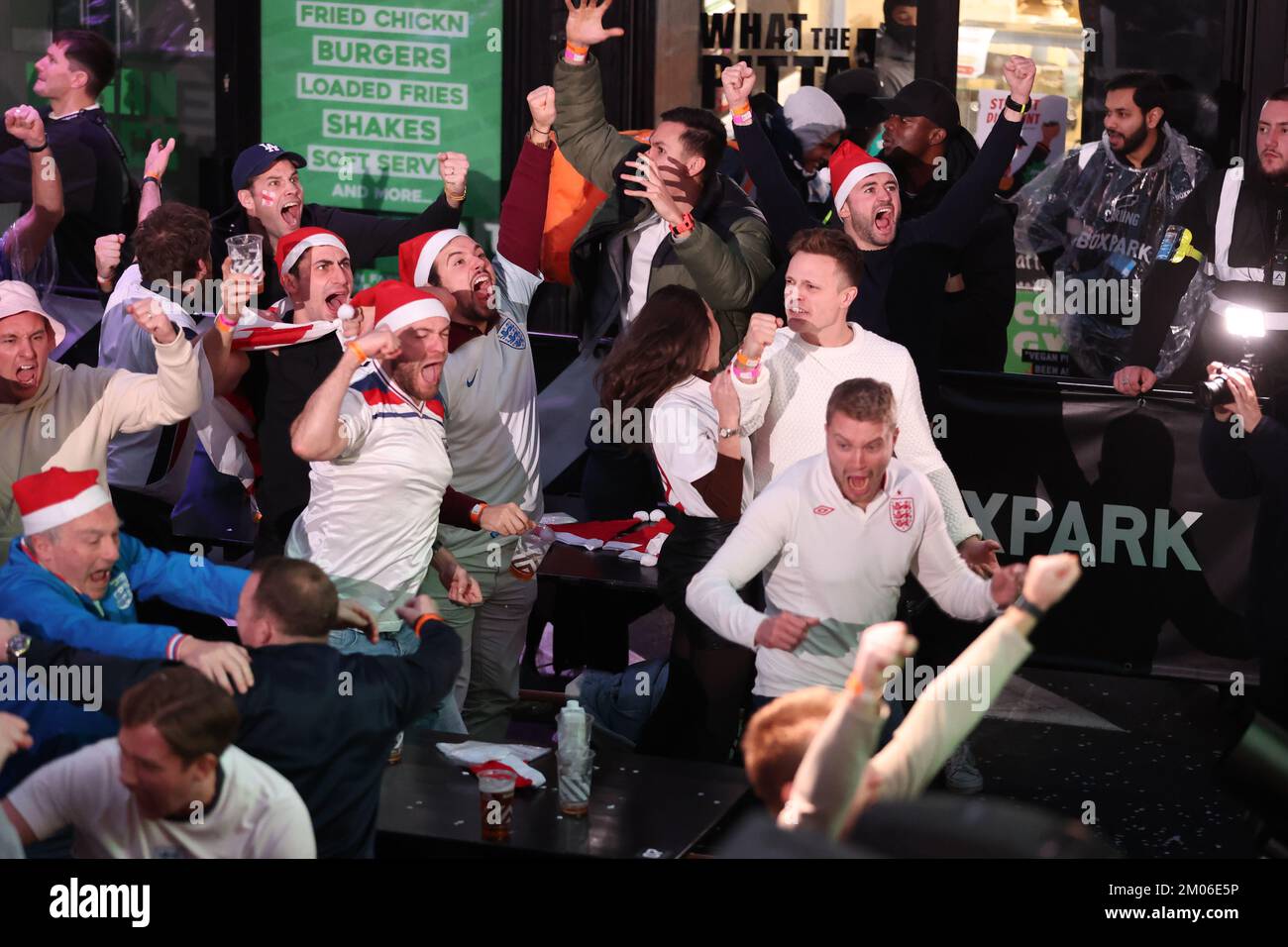 England fans celebrate their second goal at BOXPARK Croydon in London ...