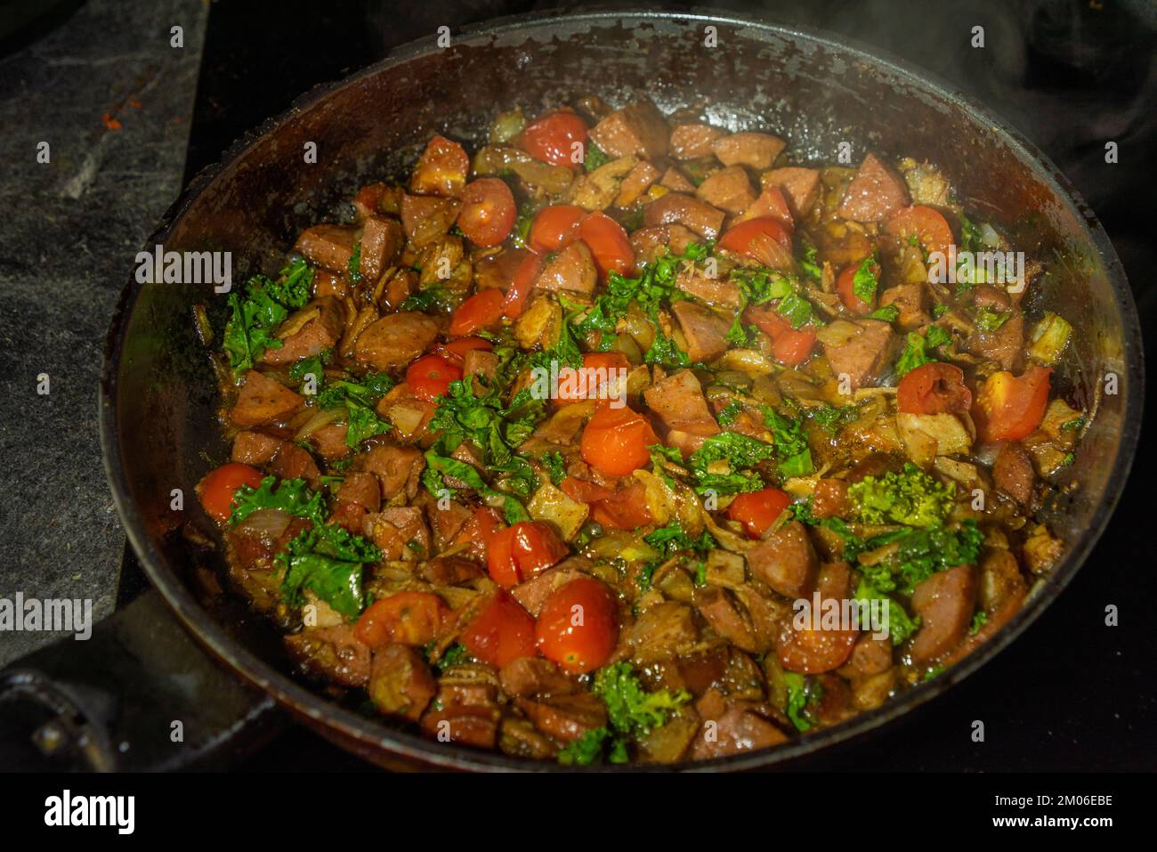 Goulash with sausage and tomato and color green vegetable Stock Photo ...