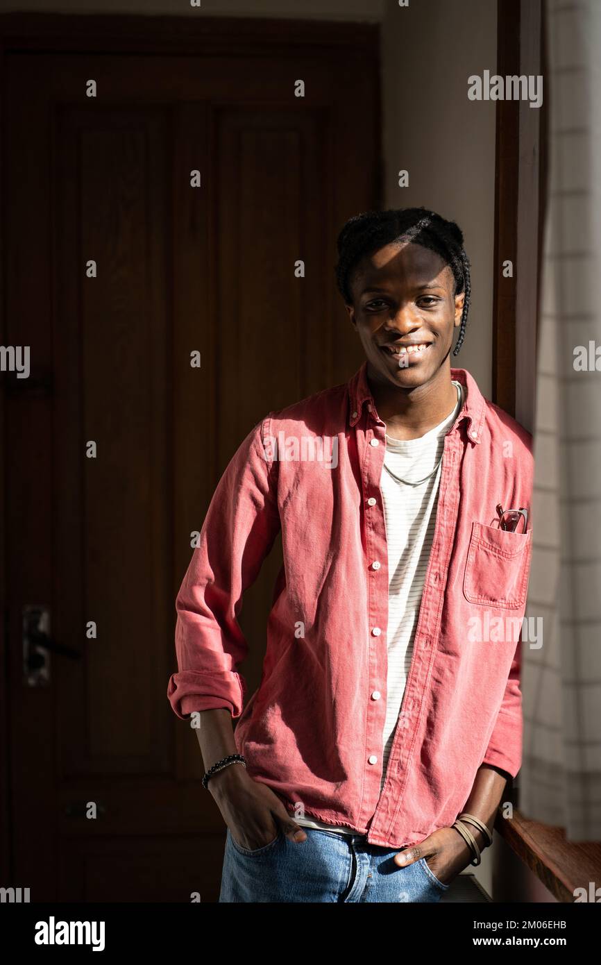 Delighted smiling African American hipster man in pink shirt standing ...