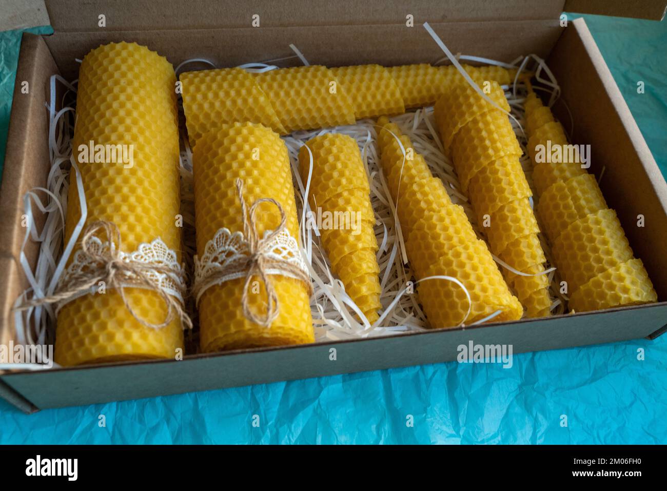 Seven beeswax candles in a box. The candles are decorated with lace and ...