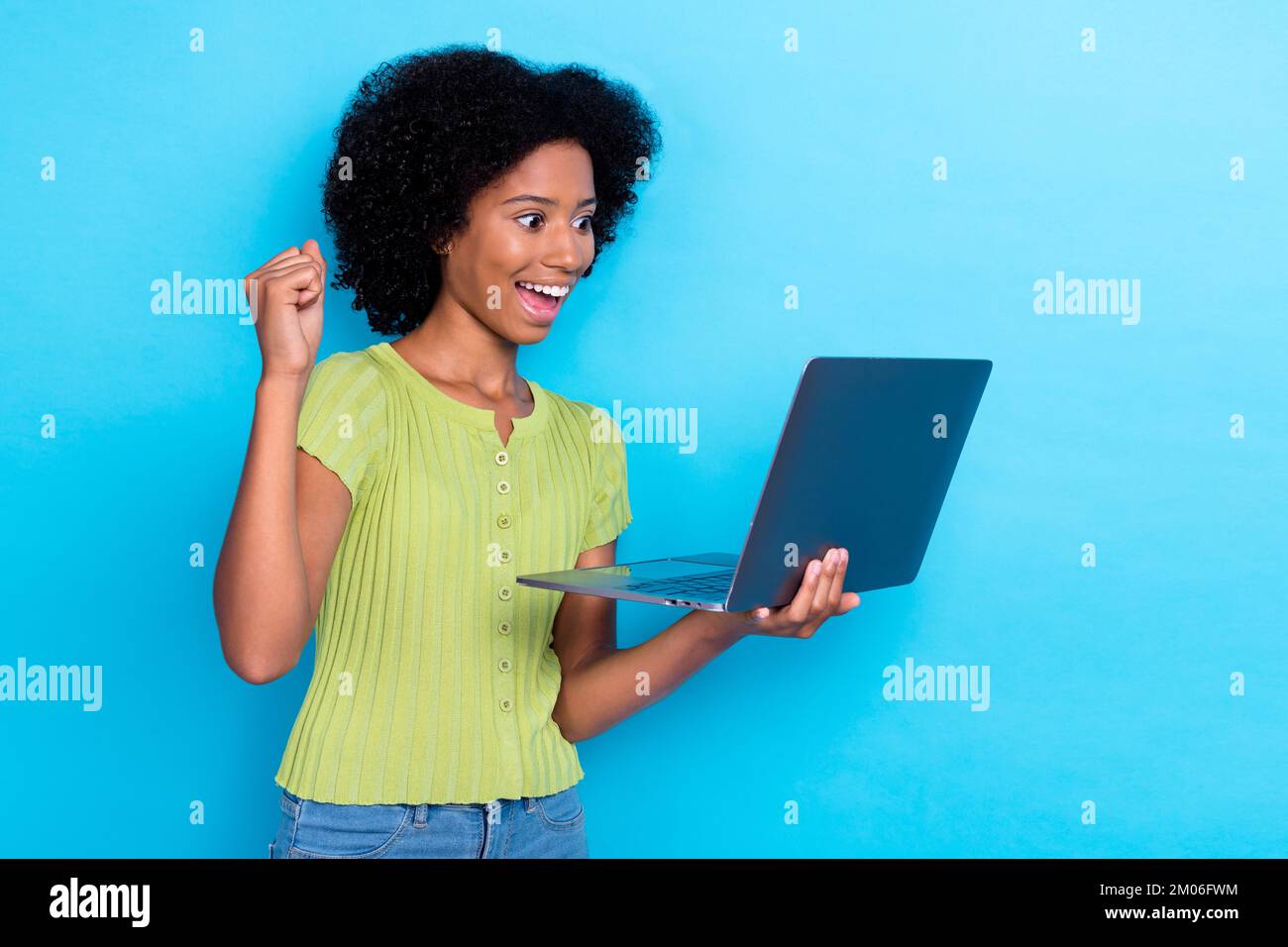 Portrait of ecstatic overjoyed girl with wavy hairdo dressed green t ...