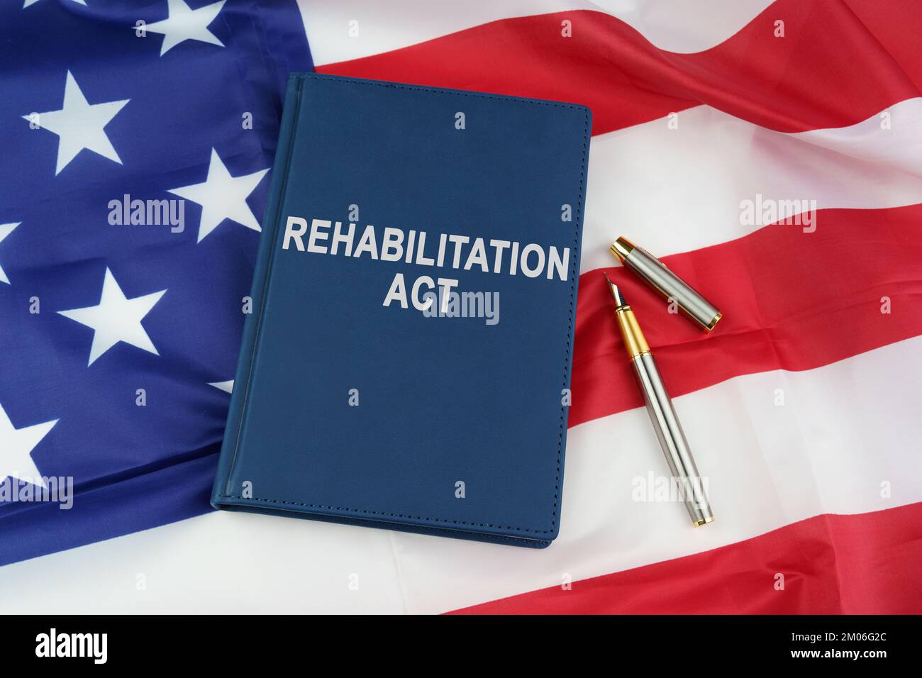 Law concept. On the US flag lies a pen and a book with the inscription ...