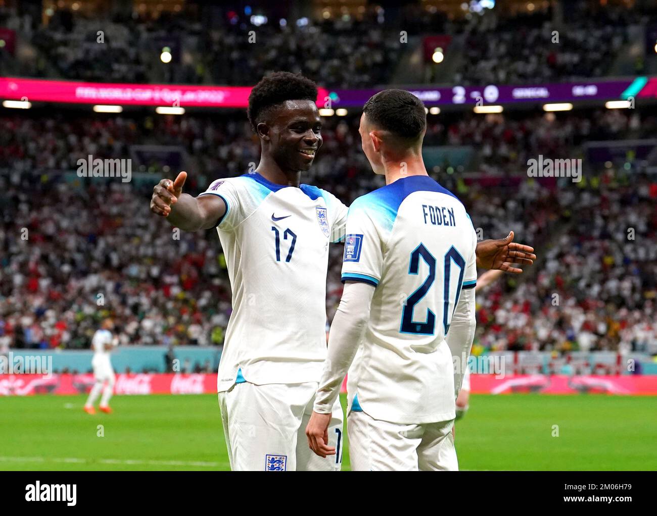 England's Bukayo Saka (left) celebrates with team-mate Phil Foden after ...