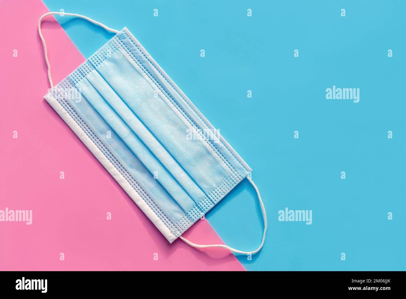 Ear loop face mask layers, protective masks on a blue and pink ...