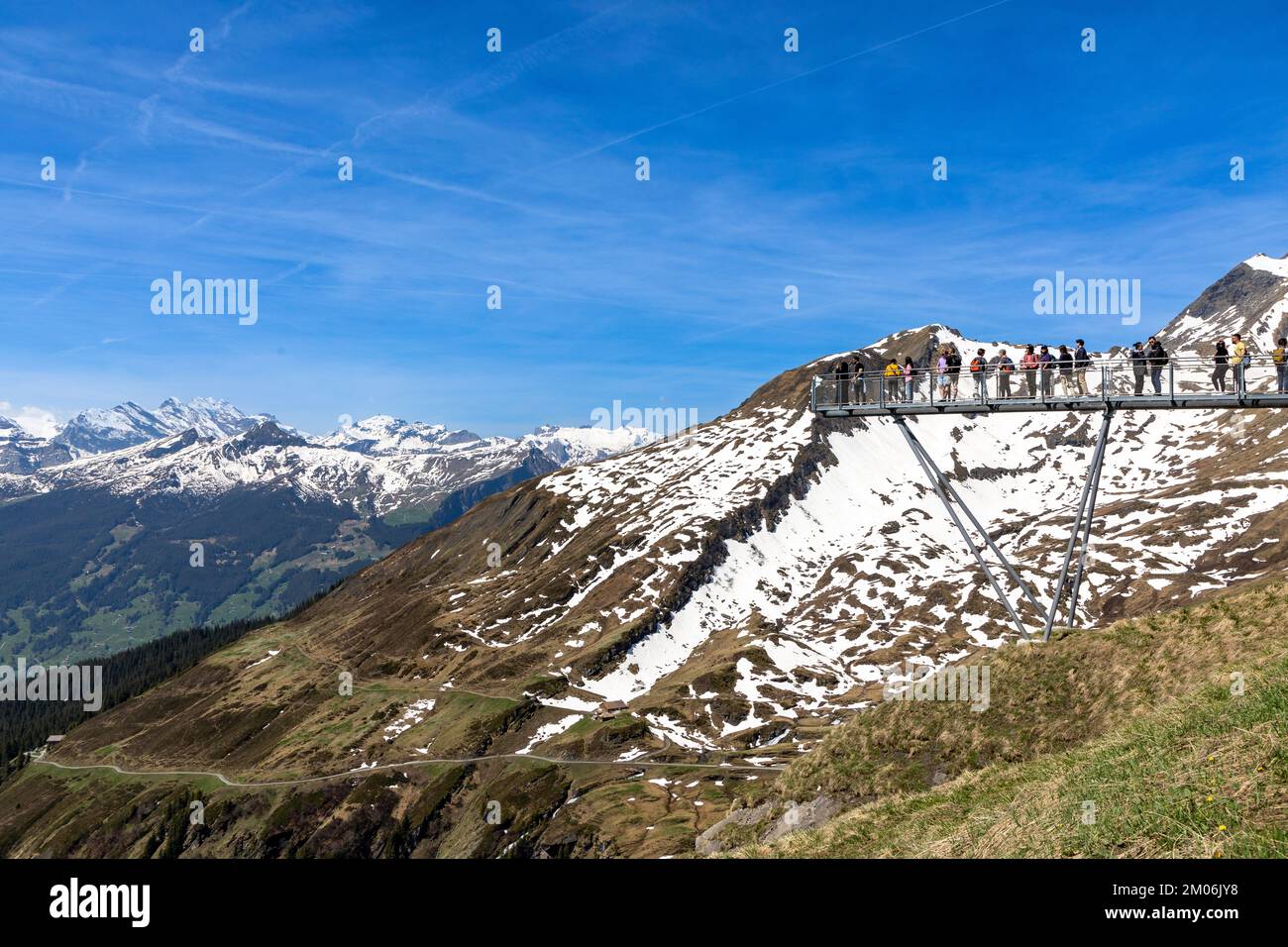 Mountains in the Swiss Alps with people standing on the platform at the ...