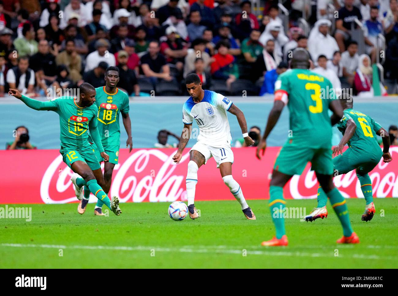 England's Marcus Rashford (centre) and Senegal's Fode Ballo-Toure (left ...