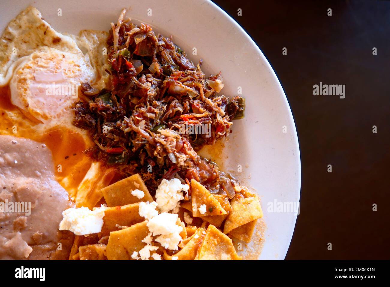 A Scrambled eggs with machaca and beans and chilaquiles Stock Photo - Alamy