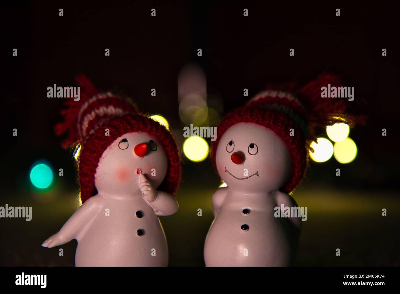 Snowman with hat and blurry lights Stock Photo - Alamy