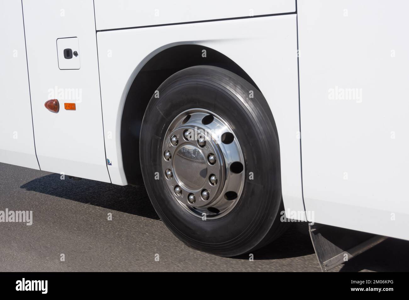 Wheel of a white bus close up, with a shiny disc Stock Photo - Alamy
