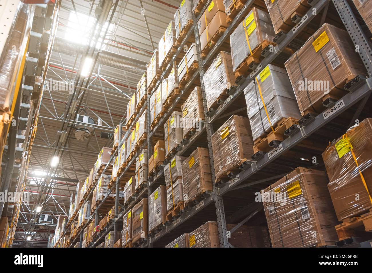 Retail warehouse full of shelves with goods in wooden crates, boxes and ...