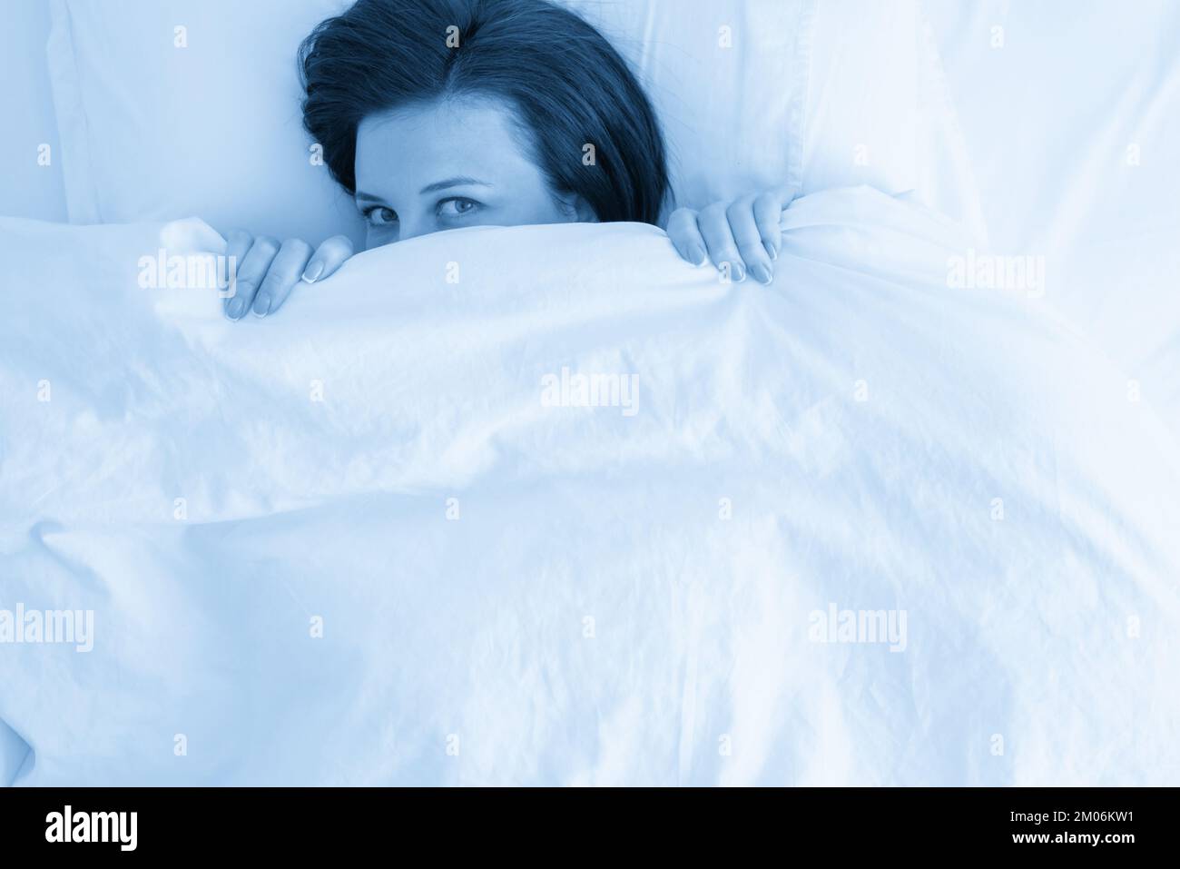 Woman covered in sheet lying in bed hi-res stock photography and images ...