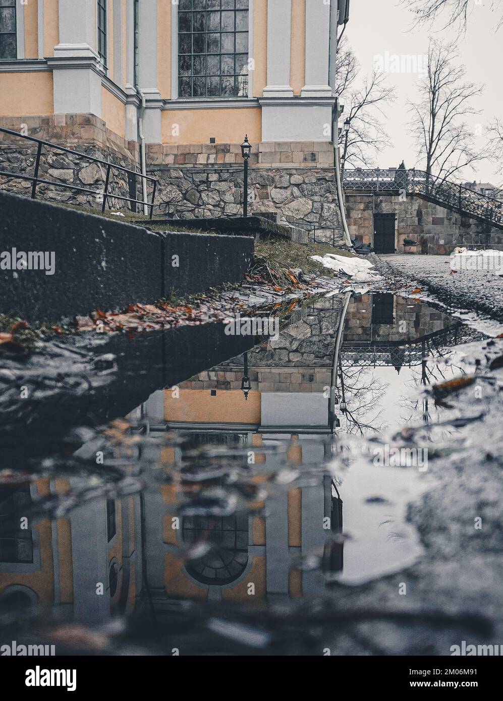 View of puddle next to a church during winter Stock Photo - Alamy