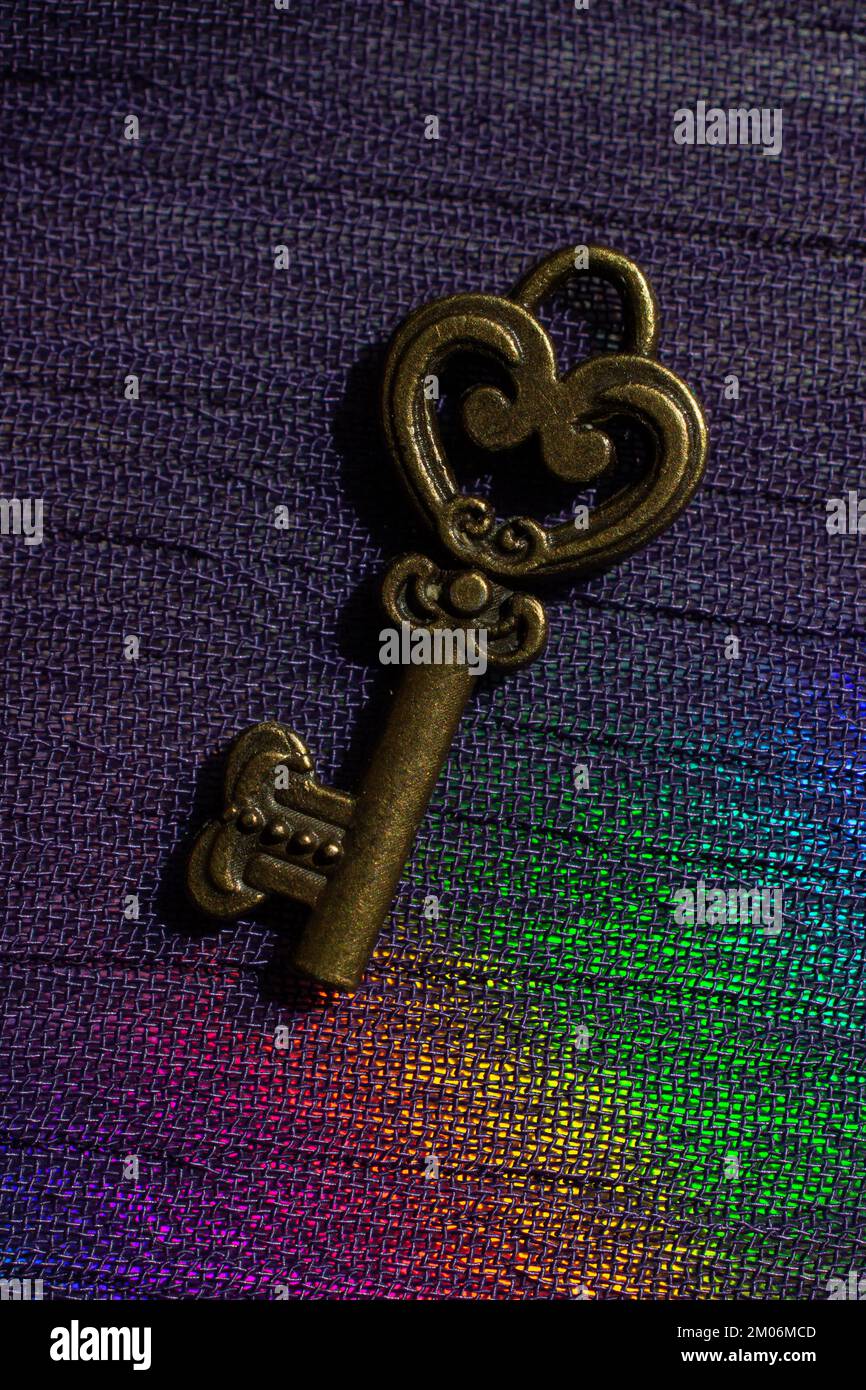 Vintage key. .Antique key. Retro key on colorful fabric background ...