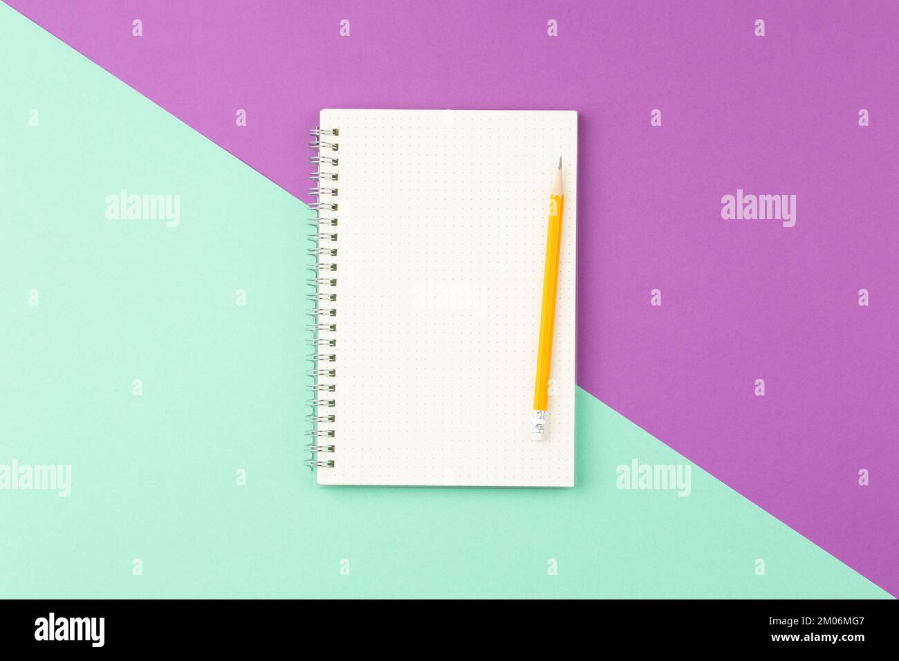 Spiral notepad with white pencil Stock Photo - Alamy