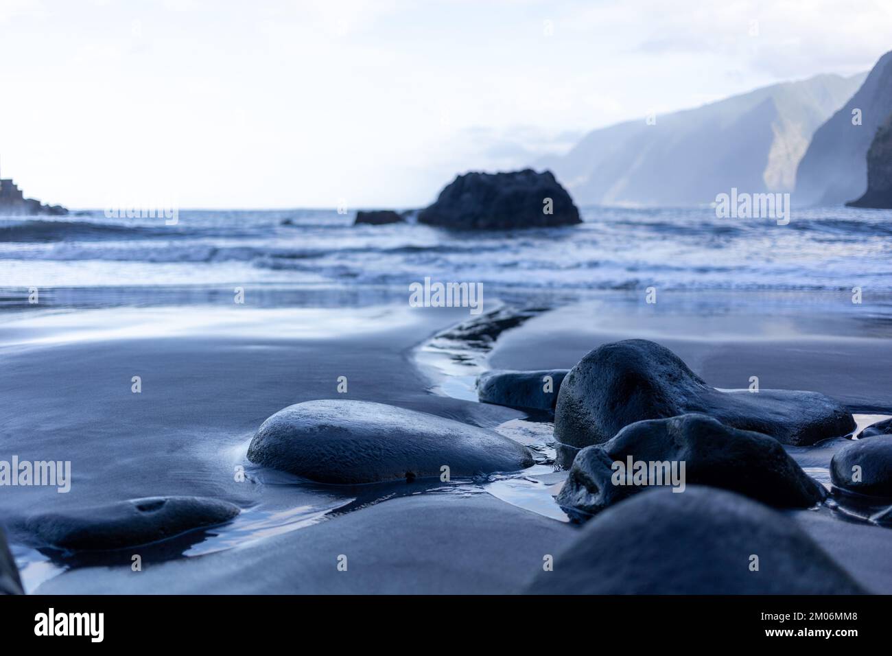 black sand beach of Madeira view on mountains Stock Photo - Alamy