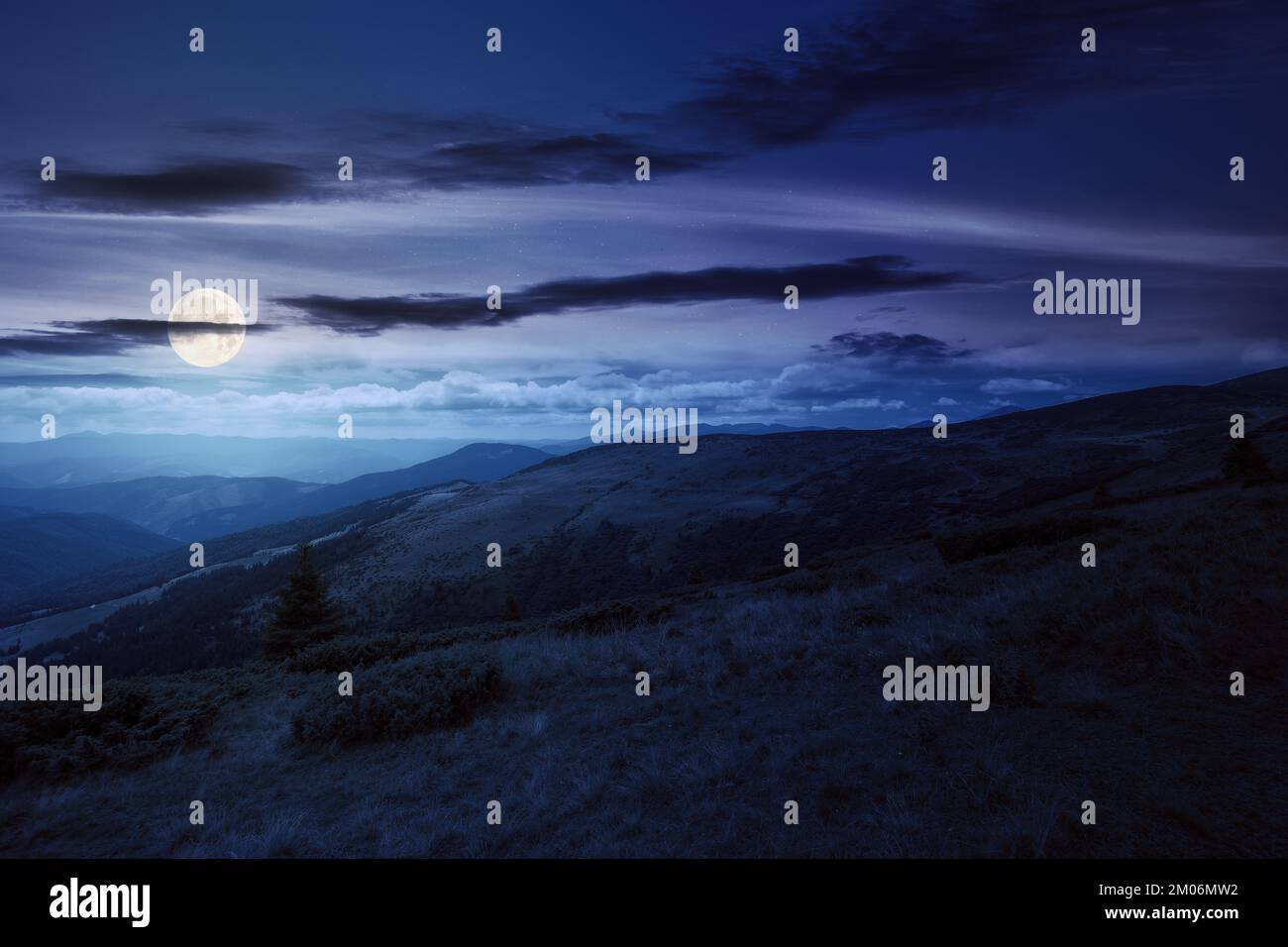 view in to the mountain valley at night. beautiful summer landscape of ...