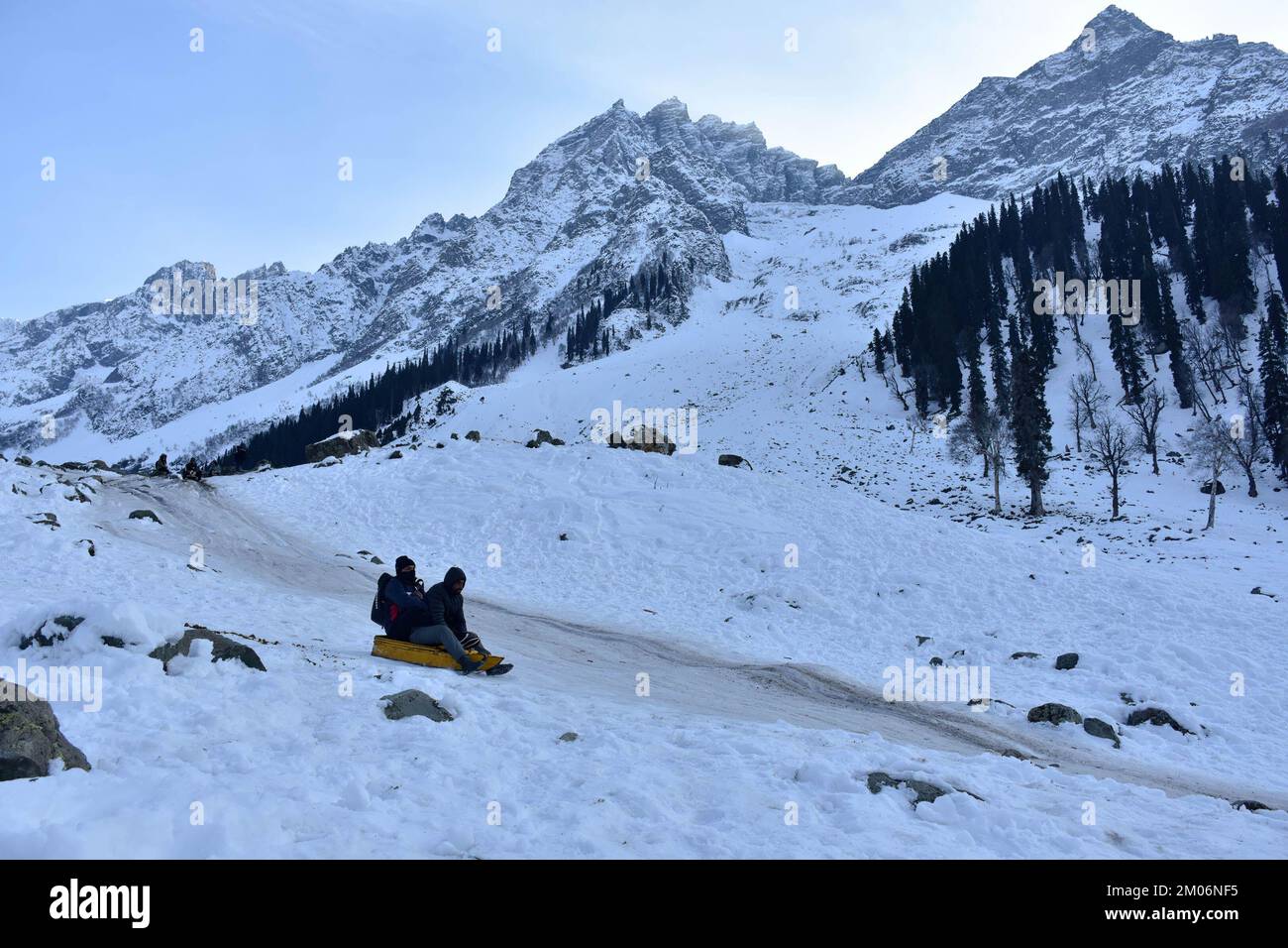 Indian tourists enjoy a sledge ride on a snow covered slope at Thajwas ...