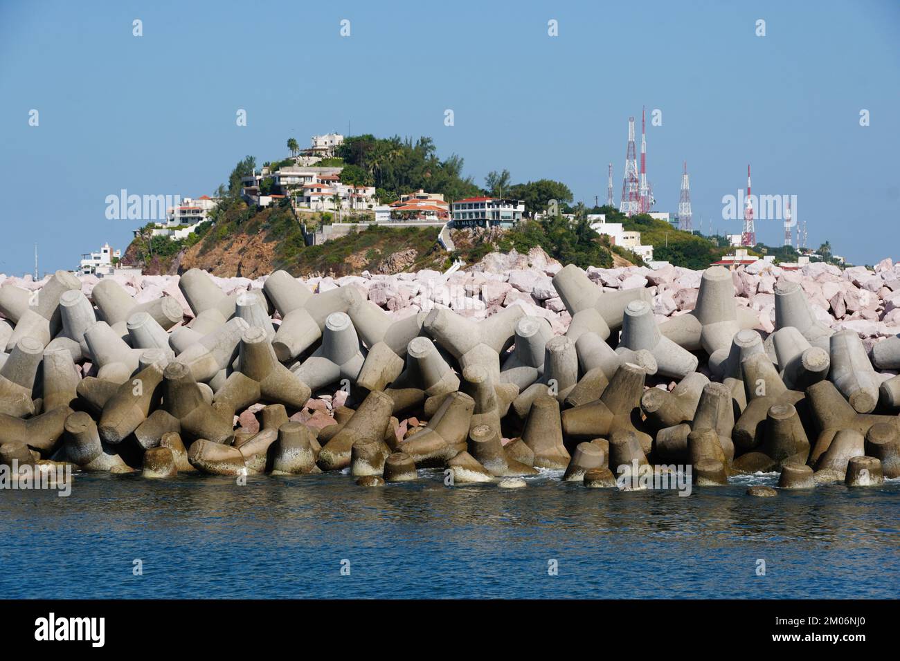 The view of the man made concrete ocean wall by the hill of El Faro ...