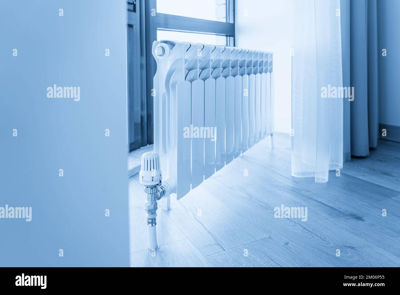 White big radiator near window in modern room Stock Photo - Alamy