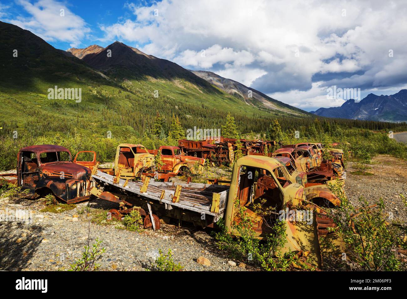 An array of abandoned rusty post war trucks that lay rusting away in ...