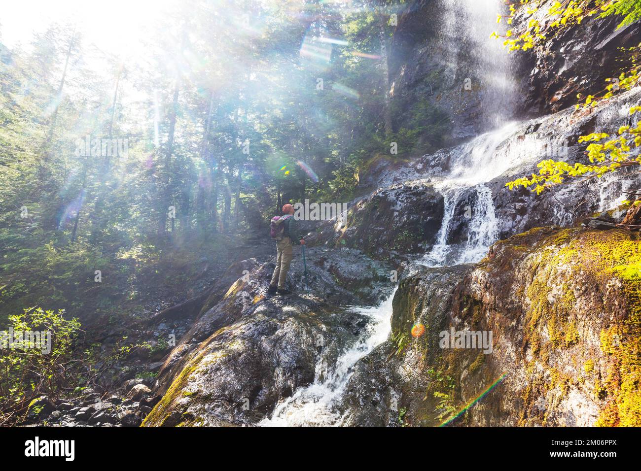 Hiker near beautiful waterfall in Canadian mountains Stock Photo - Alamy