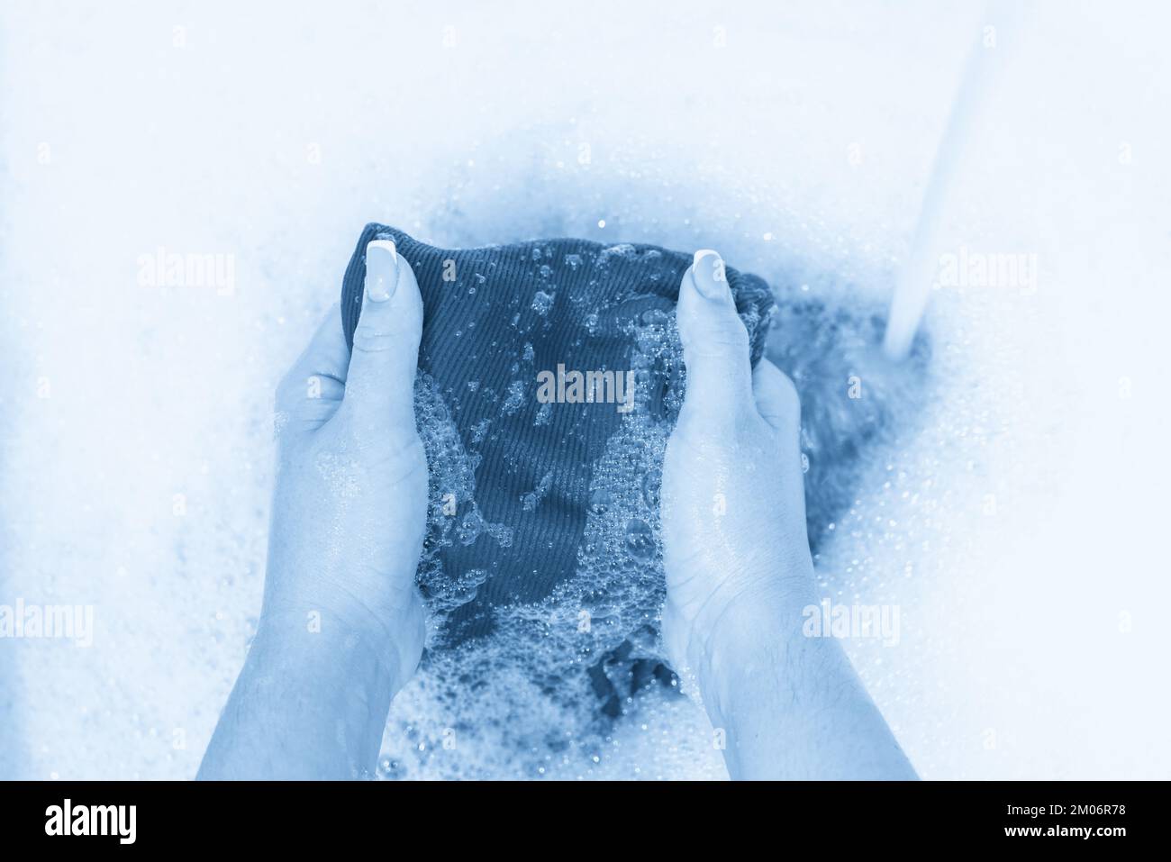 Female hands washing bright red shirt Stock Photo - Alamy